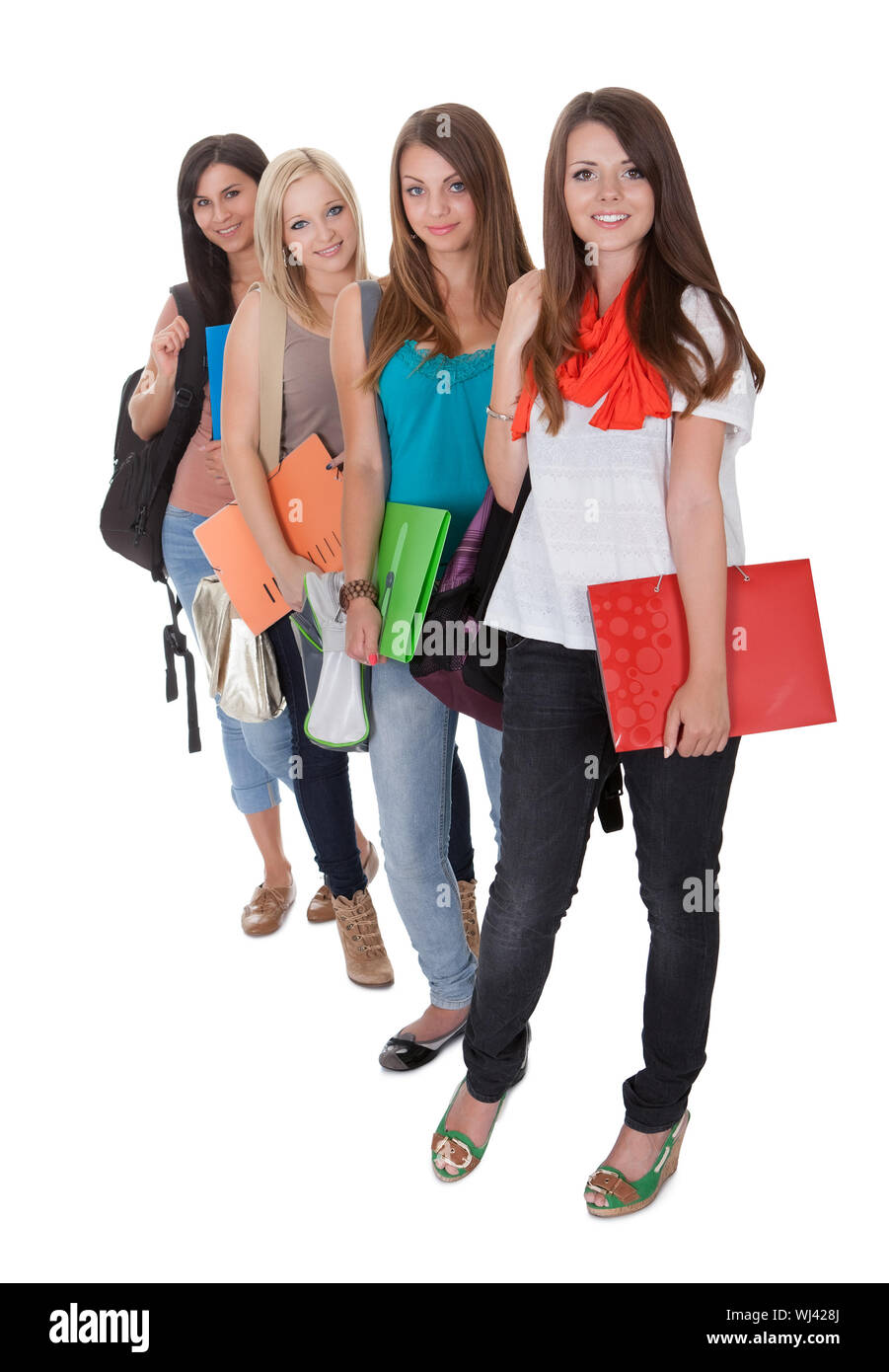Four beautiful young female students standing in a receding row with ...