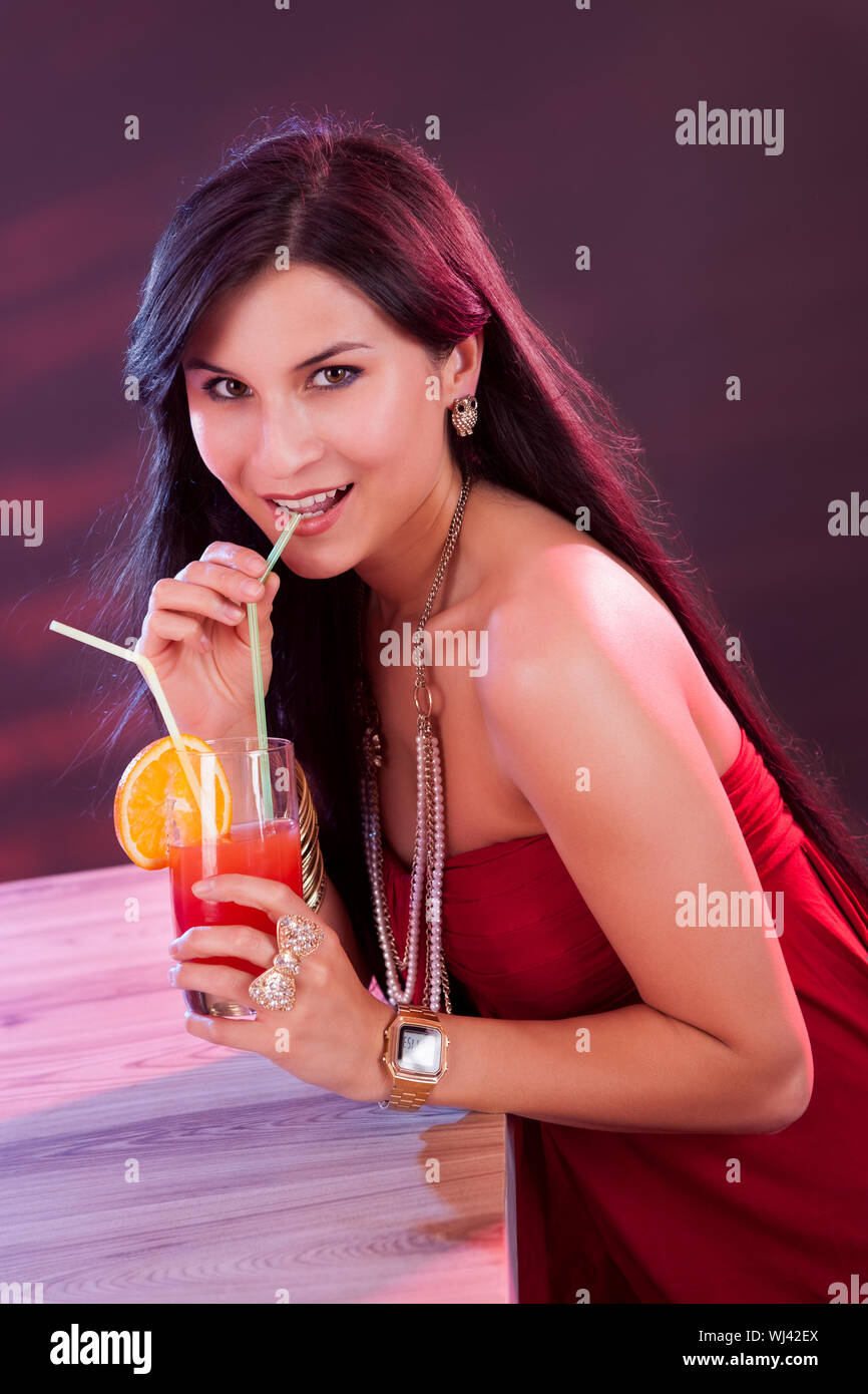 Glamorous beautiful woman in an evening dress holding a cocktail in her ...