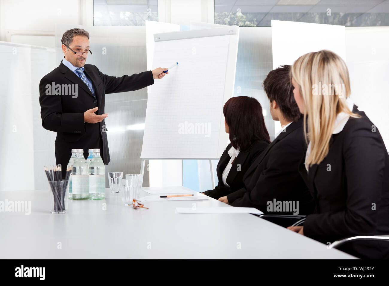 Group of business people at presentation in the office Stock Photo - Alamy