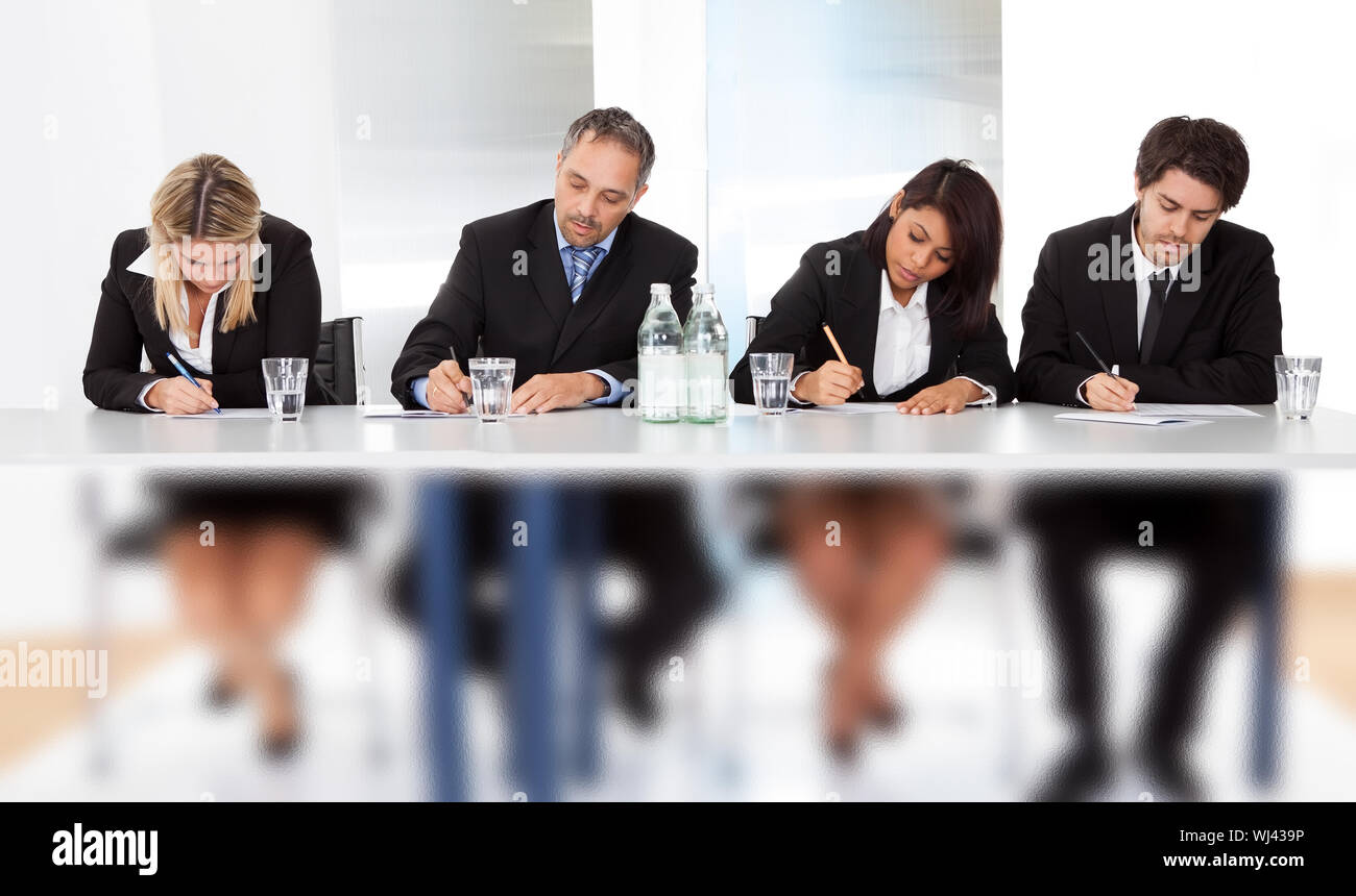 Group of business people taking notes at the meeting Stock Photo - Alamy