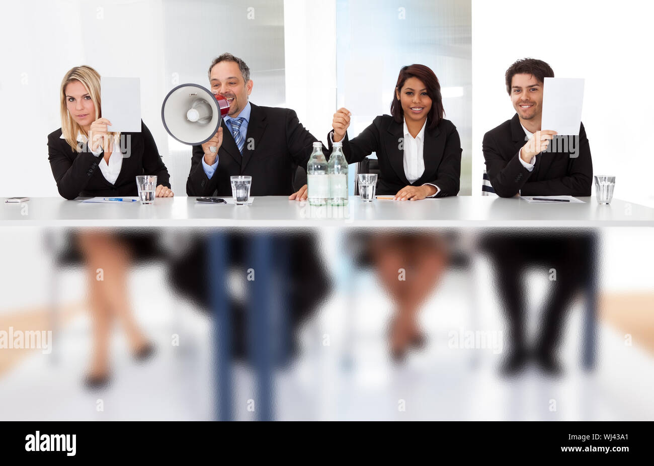 Group of panel judges holding empty score signs Stock Photo - Alamy