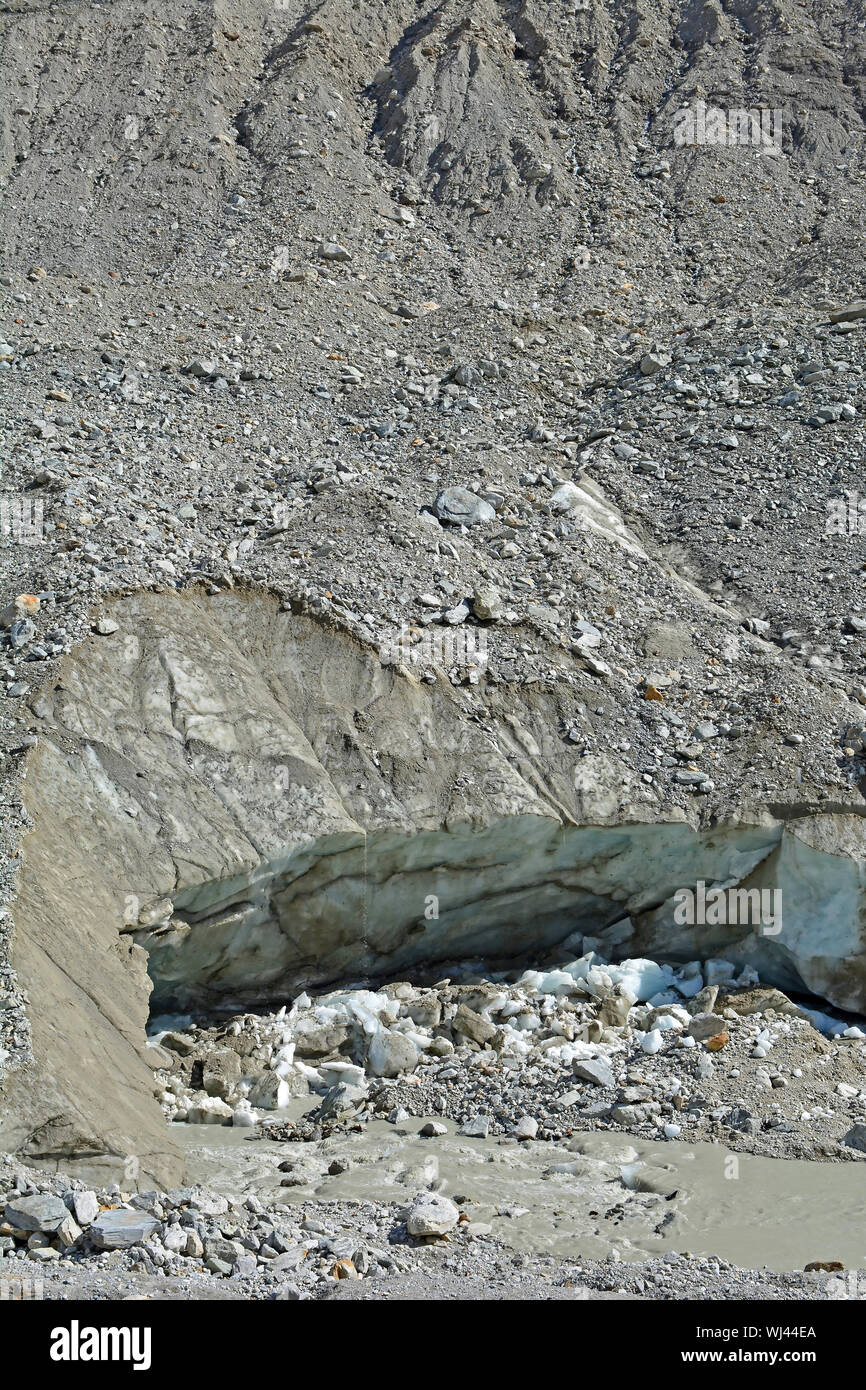 Collapsing ice cave in a glacier dug out by a meltwater river and ...