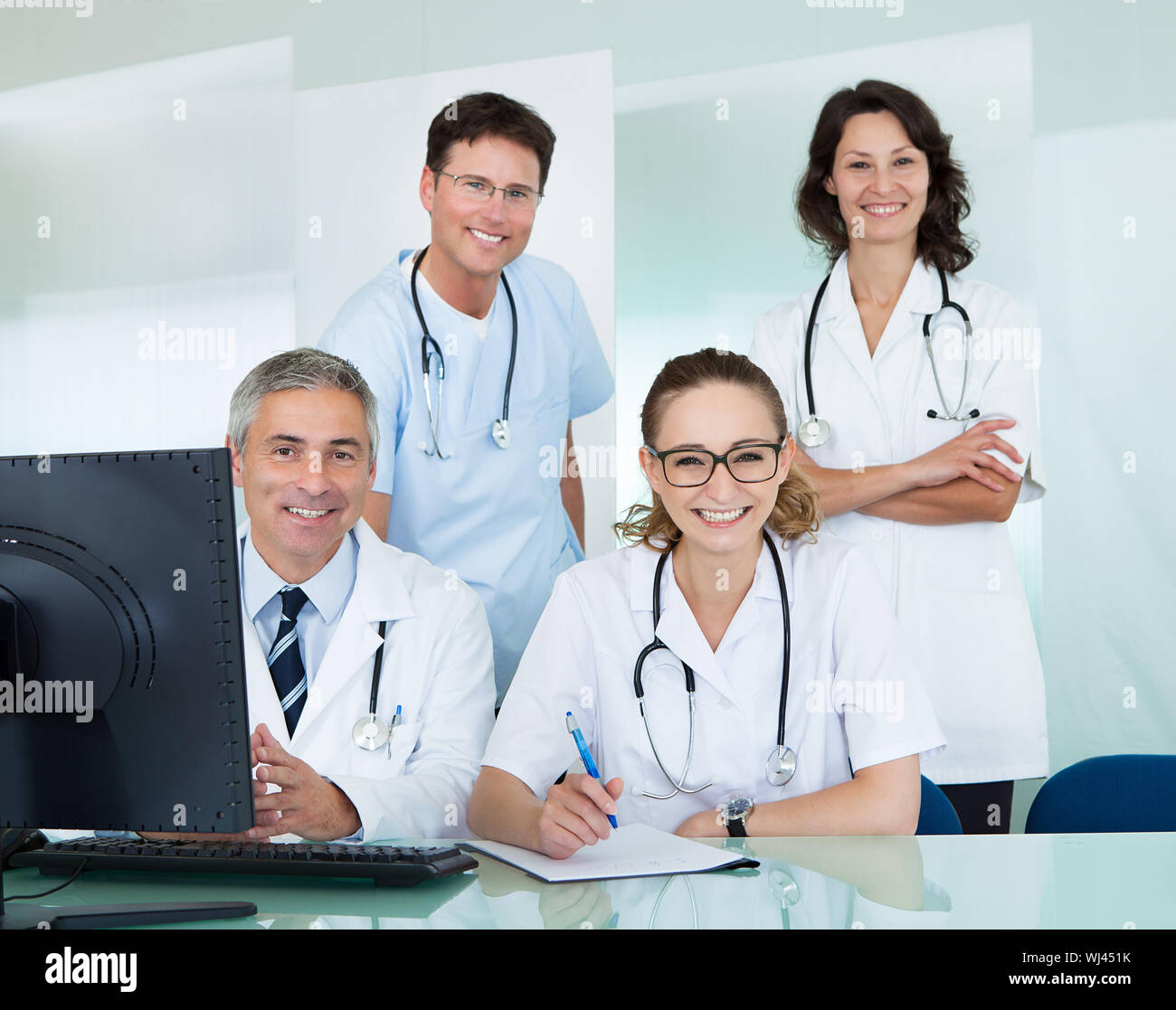 Medical team comprising male and female doctors posing together in an ...