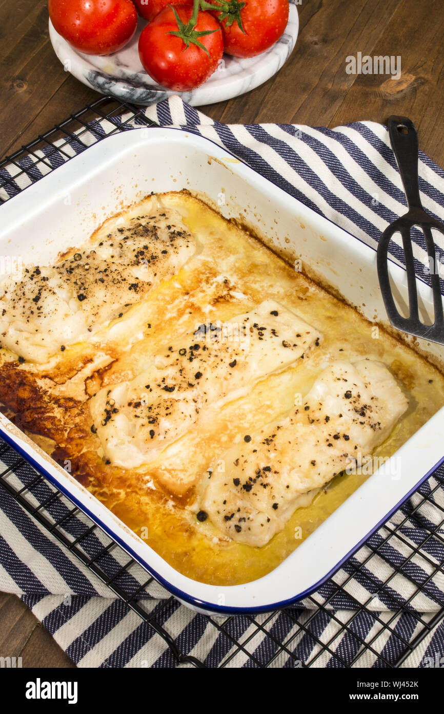 baked scottish cod in a blue and white enamel bowl Stock Photo - Alamy