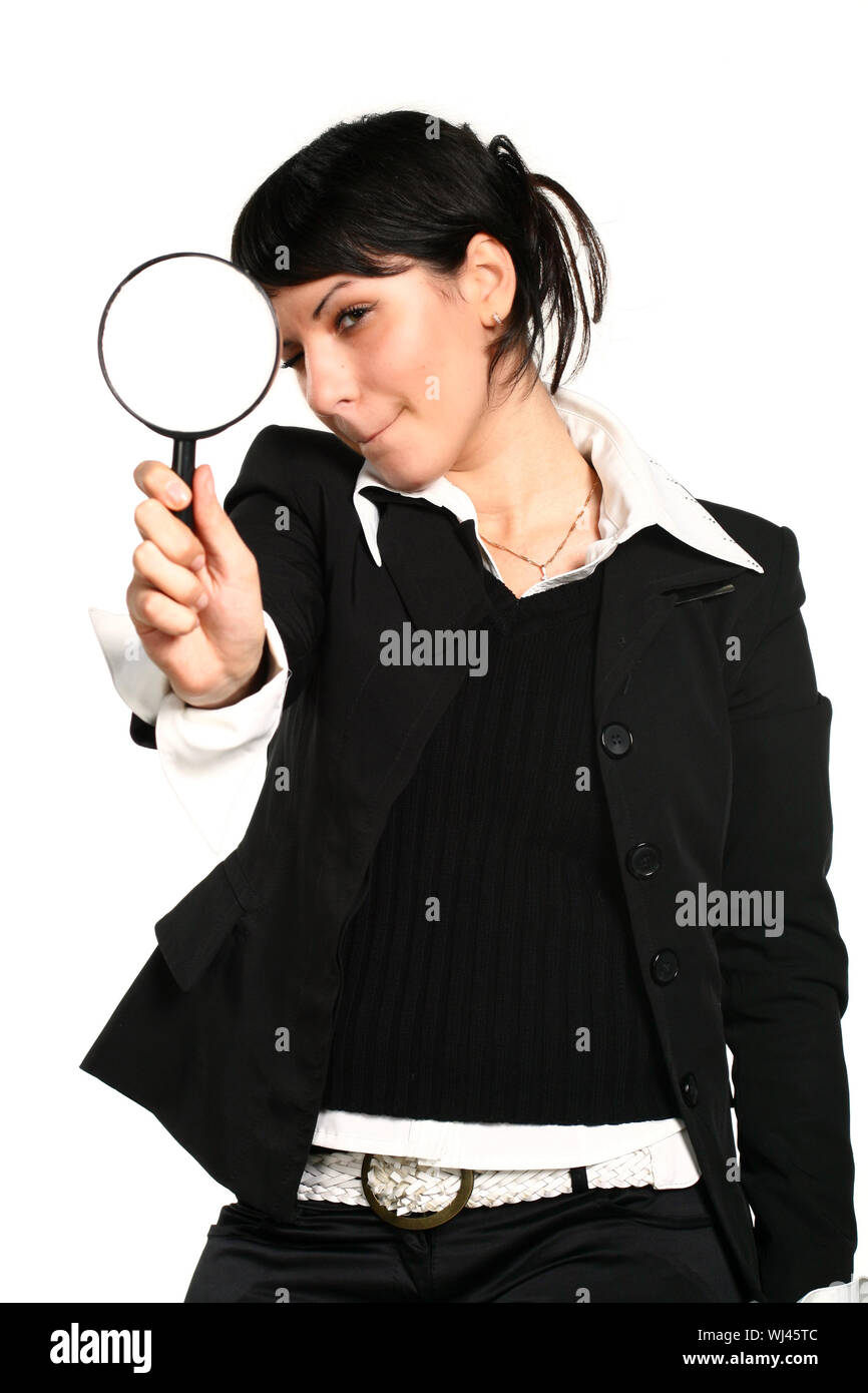 The girl searches for something through a magnifier up Stock Photo - Alamy