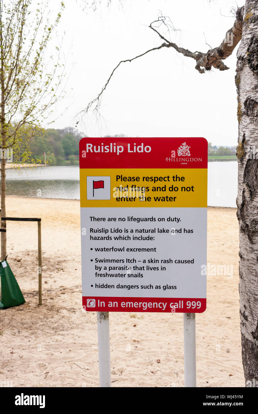 A warning sign to not enter the water at Ruislip Lido, Greater London ...