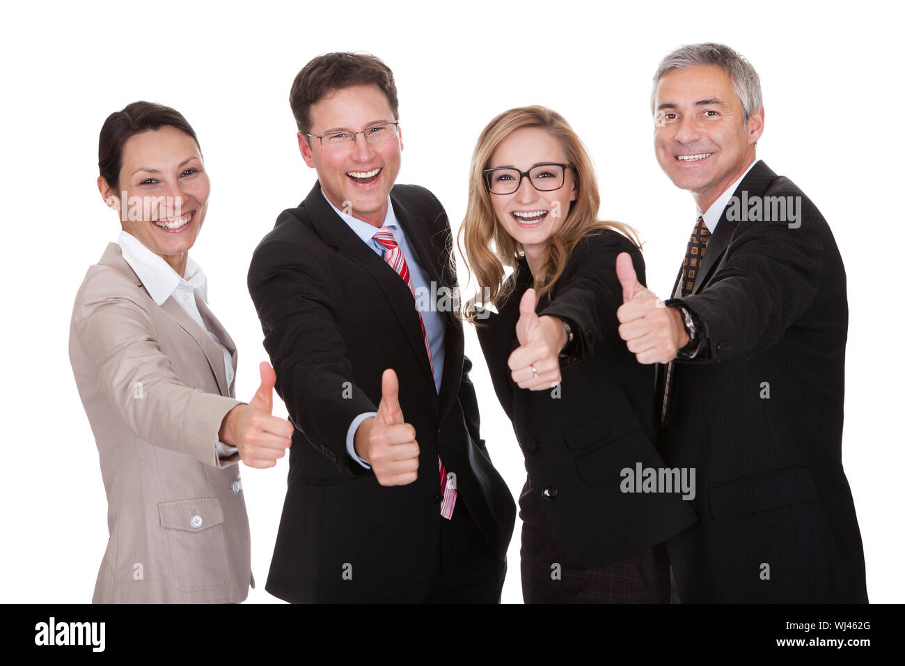 Laughing group of business executives giving a thumbs up of approval ...