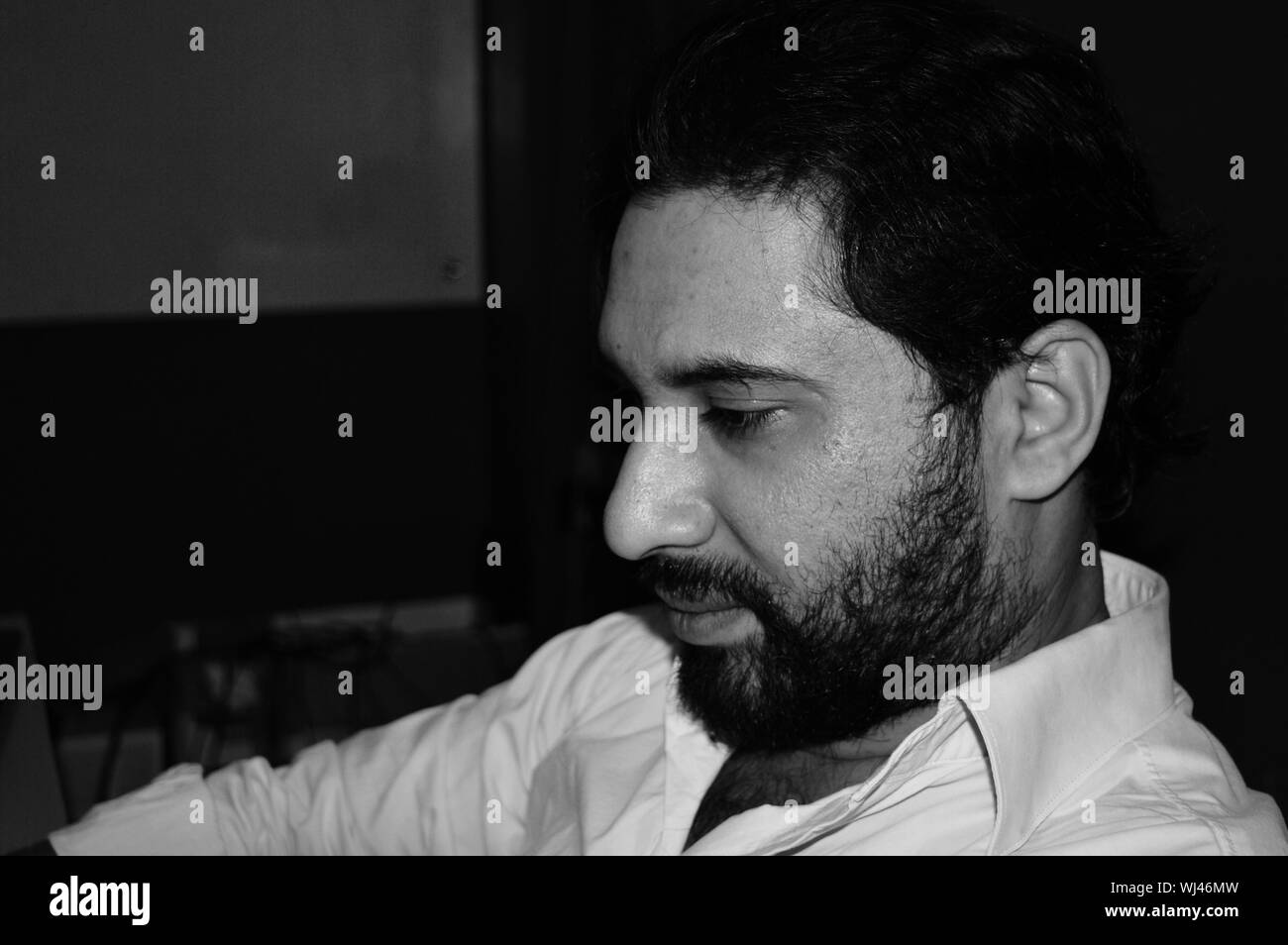 Side View Of Man Looking Down Stock Photo - Alamy