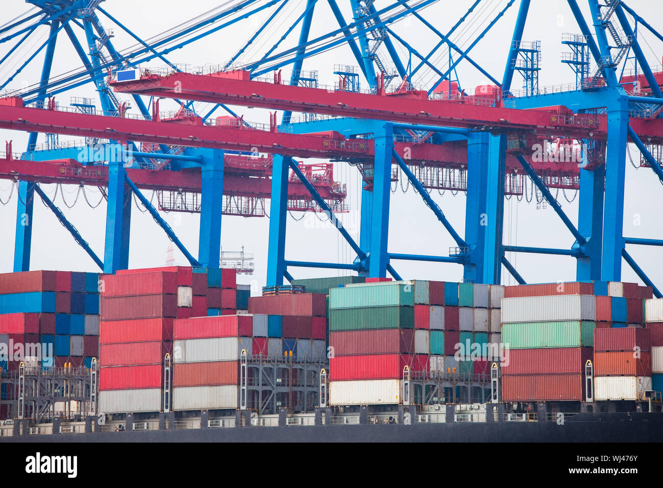 Huge container ship fully loaded in port terminal Stock Photo - Alamy