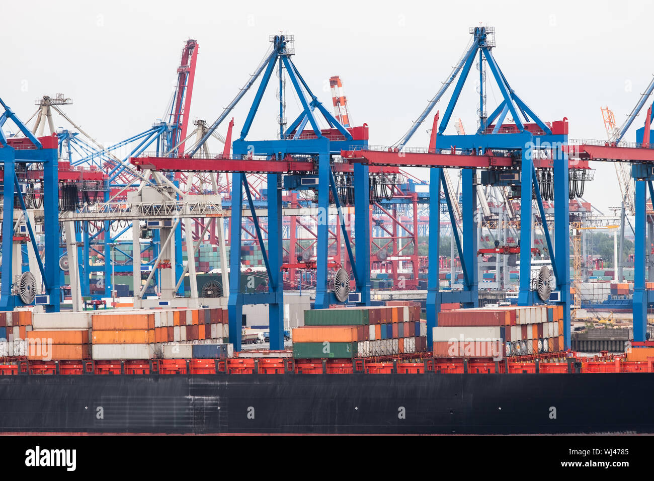 Huge container ship fully loaded in port terminal Stock Photo - Alamy