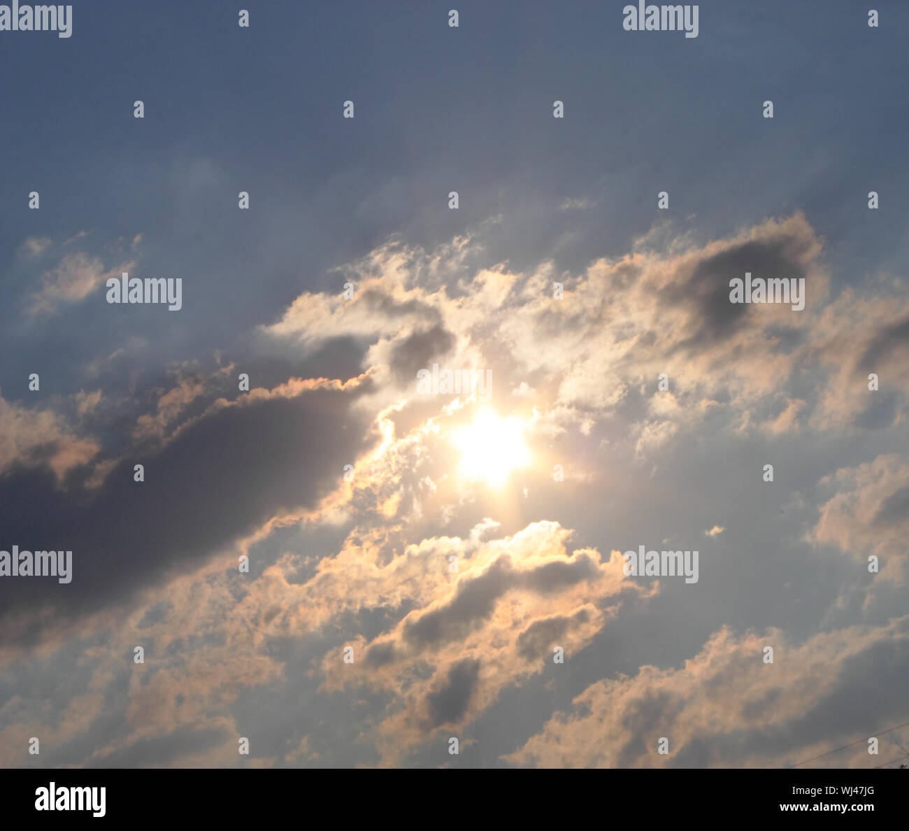 Sun in the cloudy sky Stock Photo - Alamy