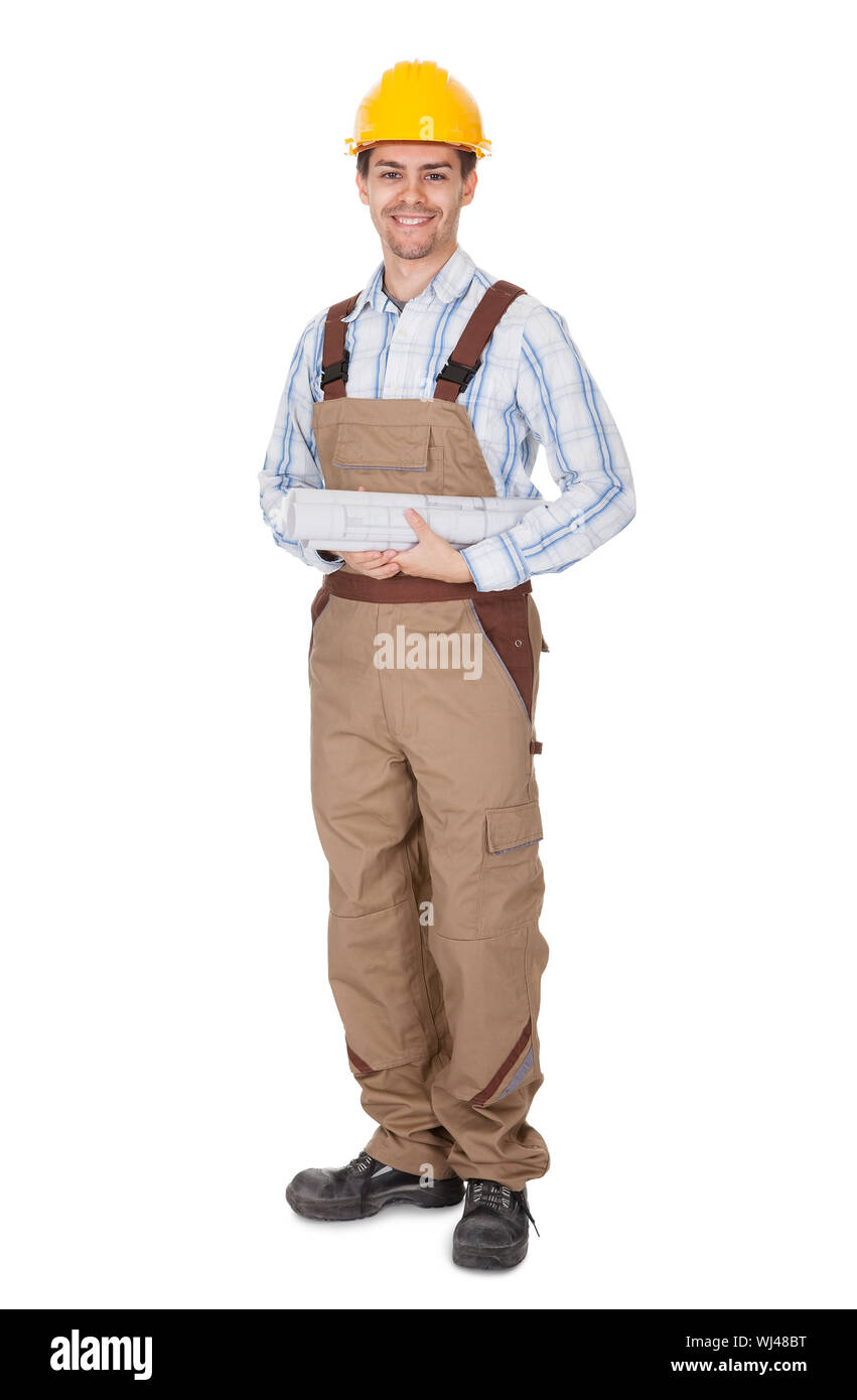 Smiling handsome handyman in work clothes with tool Stock Photo - Alamy