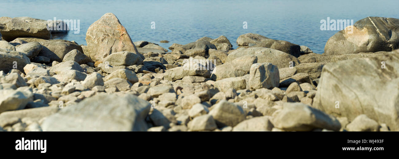 Landscape - northern cold stony coast of lake Stock Photo - Alamy