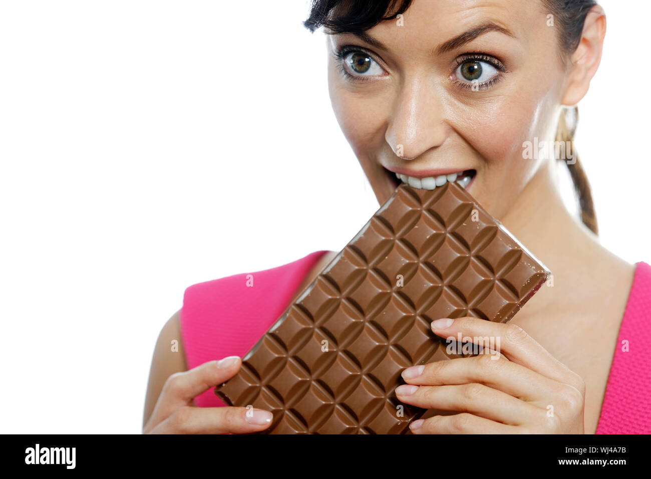 Young woman eating a huge chocolate bar Stock Photo - Alamy