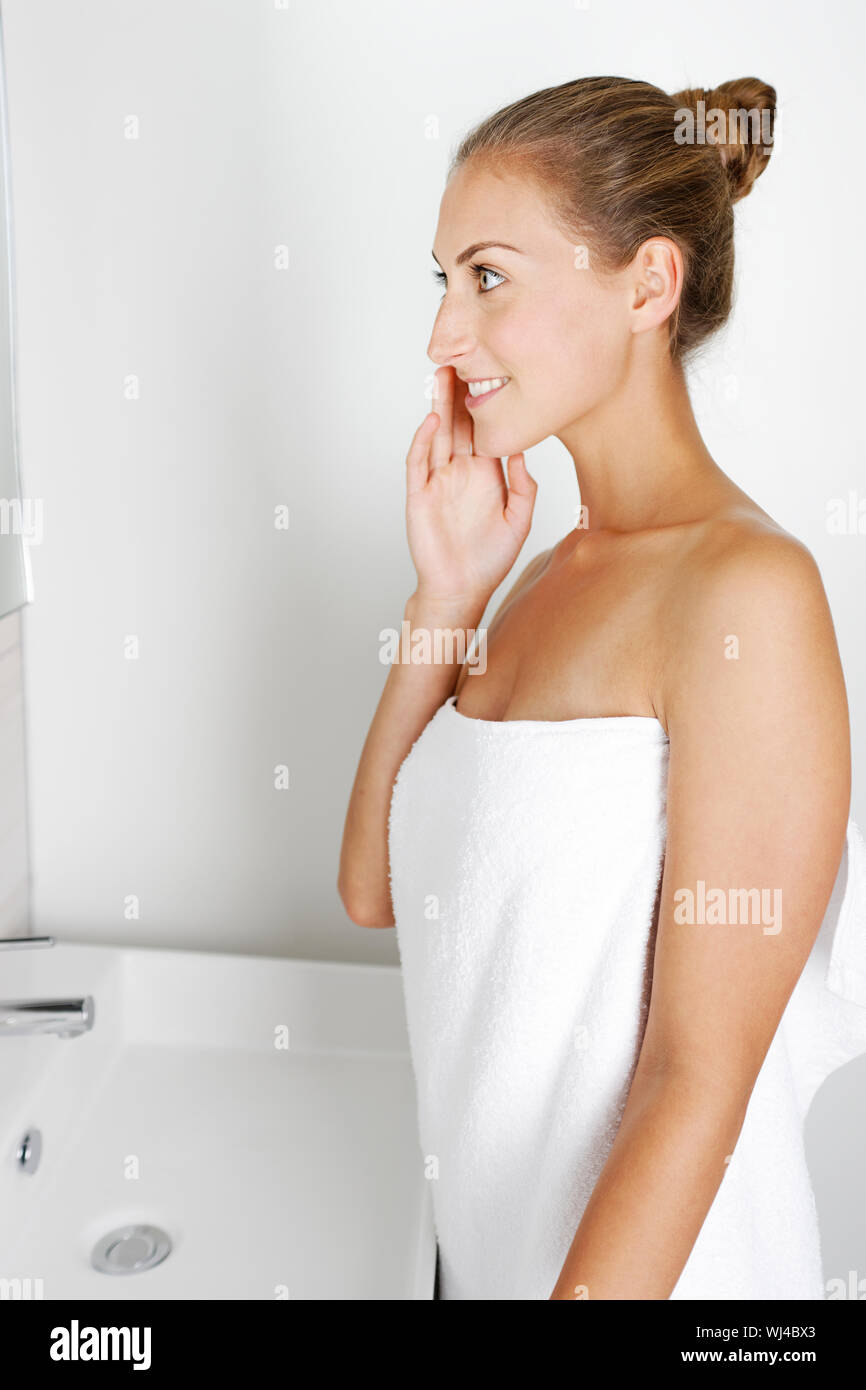 Attractive young woman in her bathroom getting ready Stock Photo - Alamy