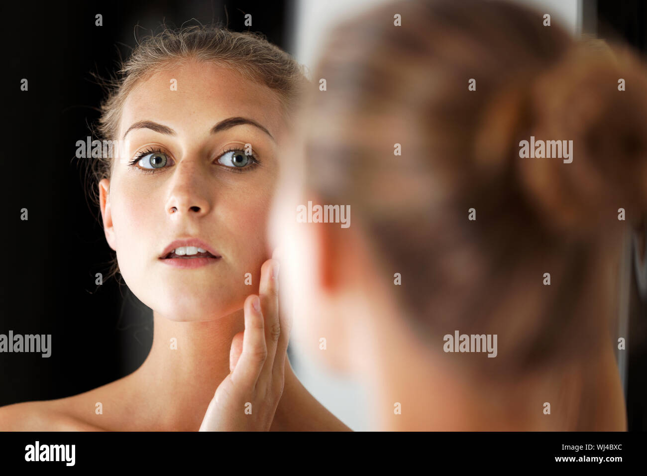 Attractive young woman in her bathroom getting ready Stock Photo - Alamy