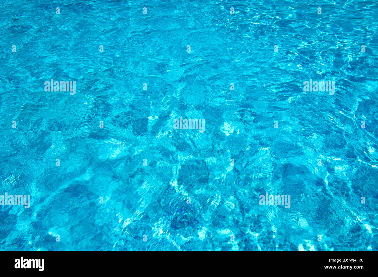 Blue pool water with sun reflections Stock Photo - Alamy