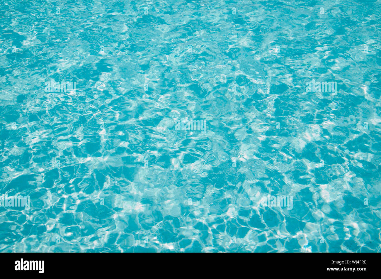 Blue pool water with sun reflections Stock Photo - Alamy