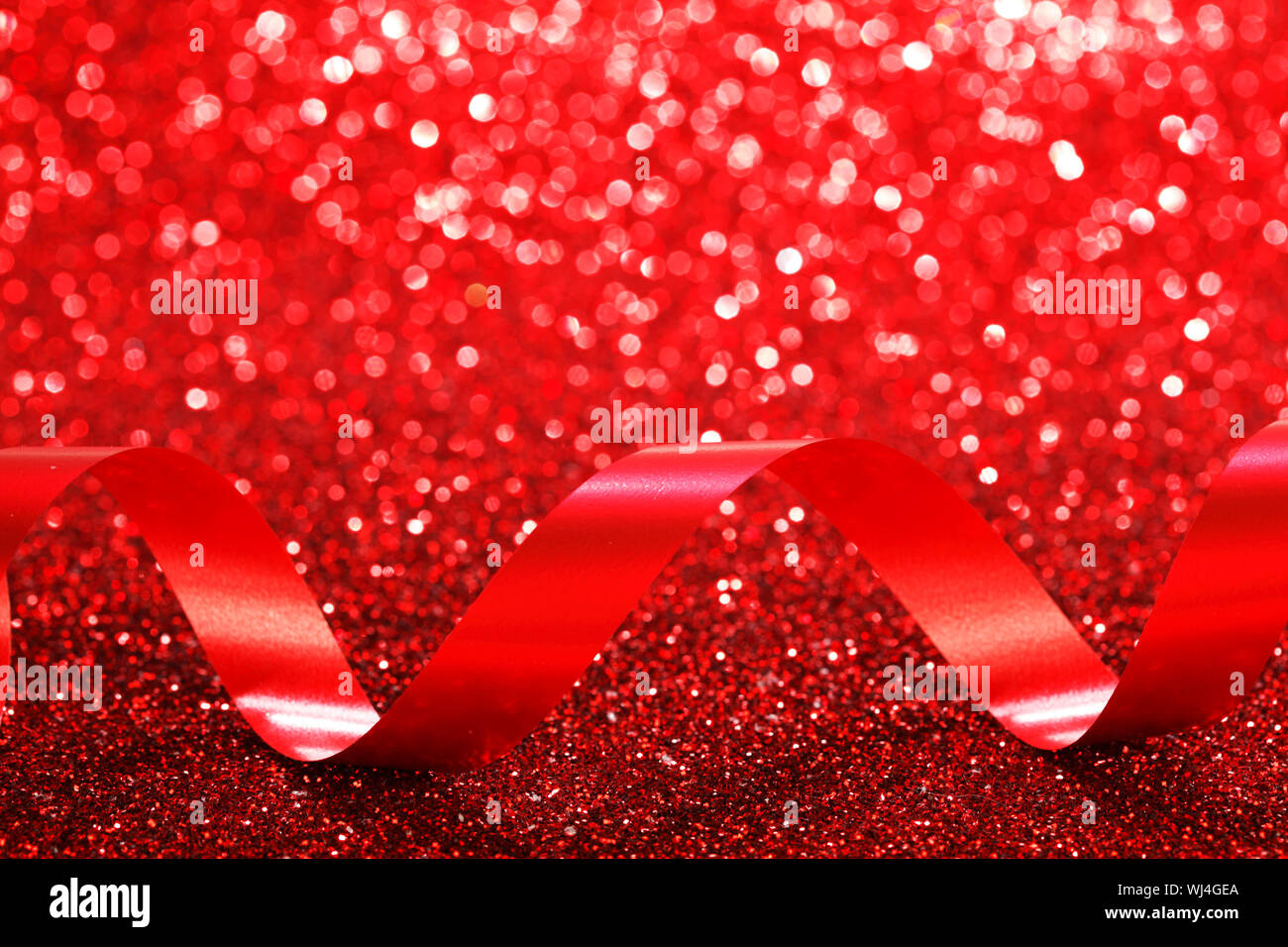 Card with red gift ribbon on shiny background Stock Photo - Alamy
