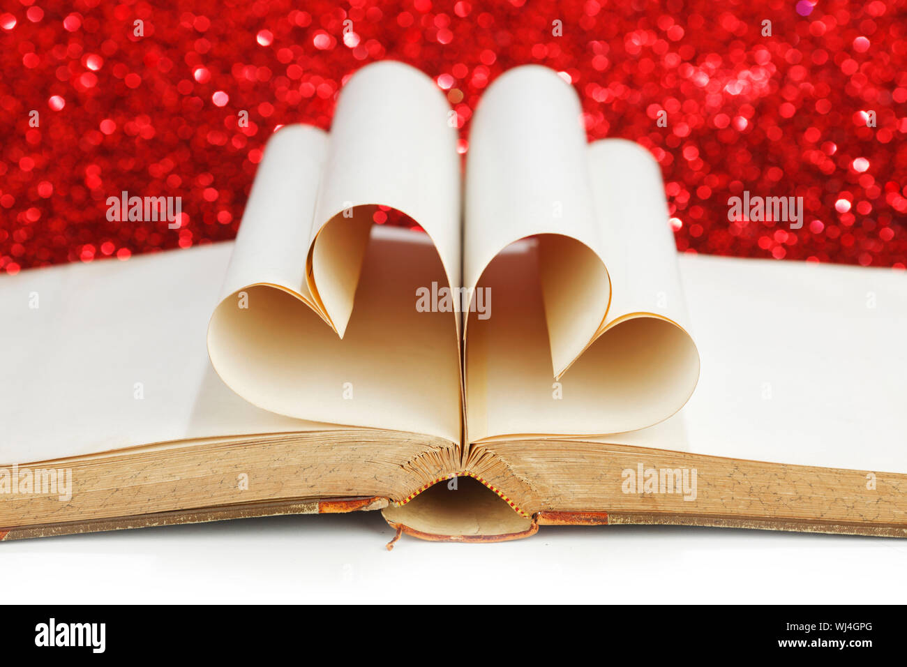 Heart made of blank pages inside a book on glitter background Stock ...