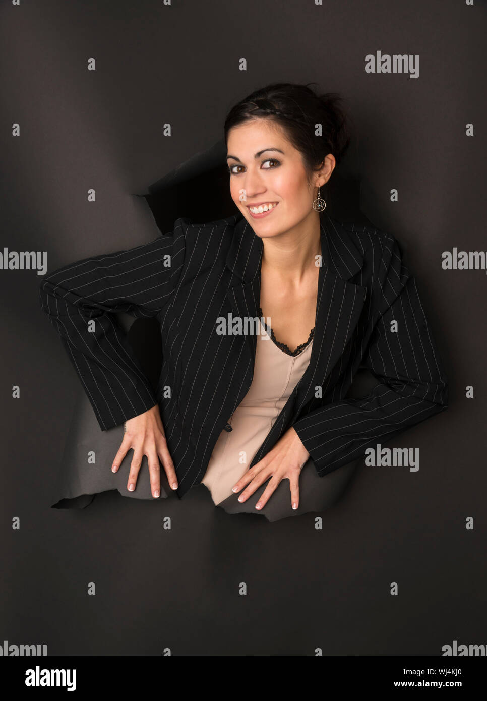Business Professional Woman breaks through back hole Stock Photo - Alamy