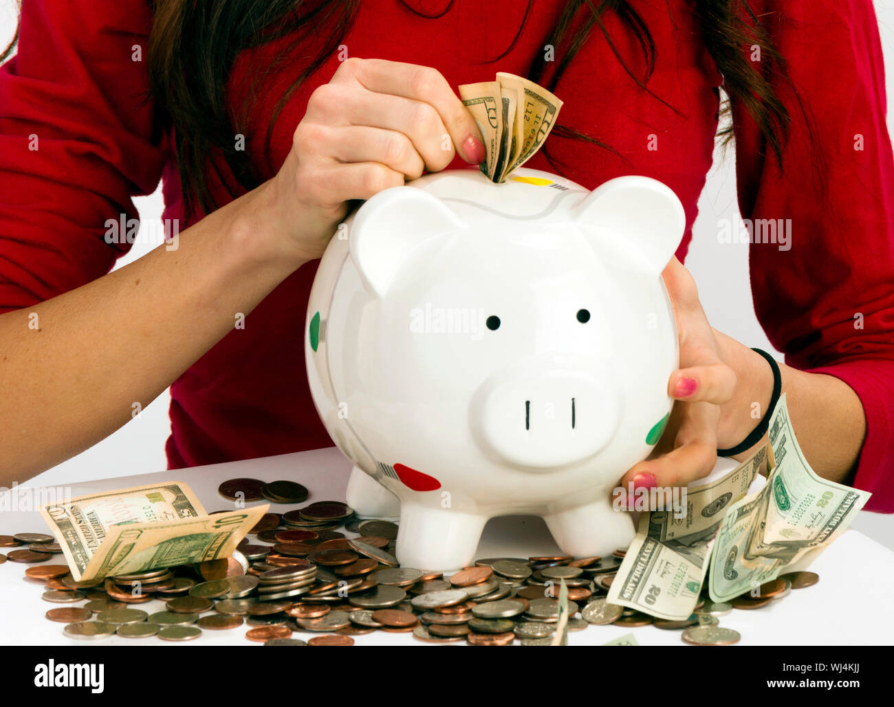 Woman saving money the old fashioned way in Piggy Bank Stock Photo - Alamy