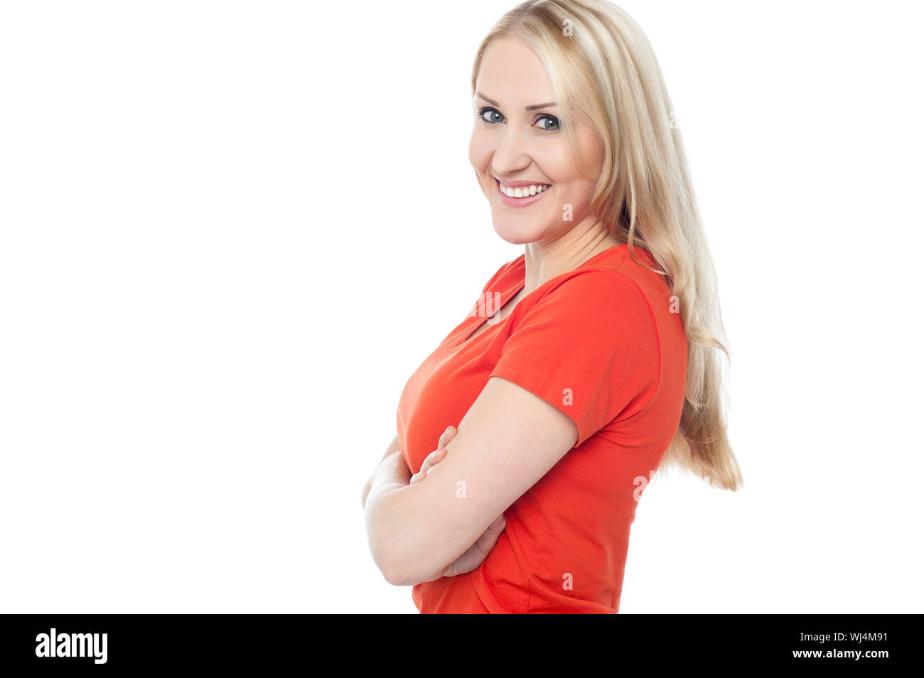 Smiling lady posing casually over white background Stock Photo - Alamy