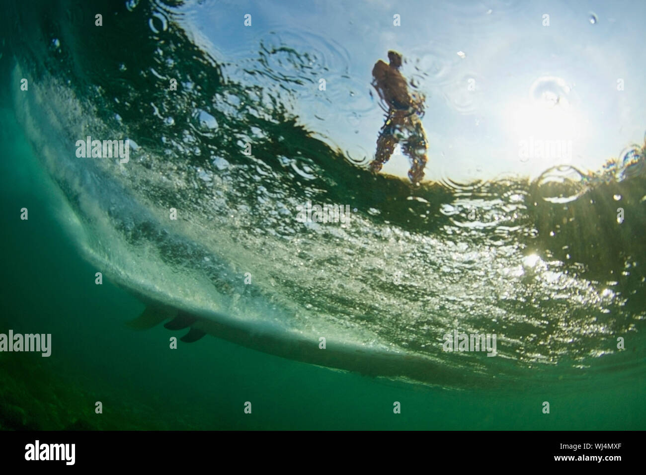 Surfboard under ocean surface Stock Photo - Alamy
