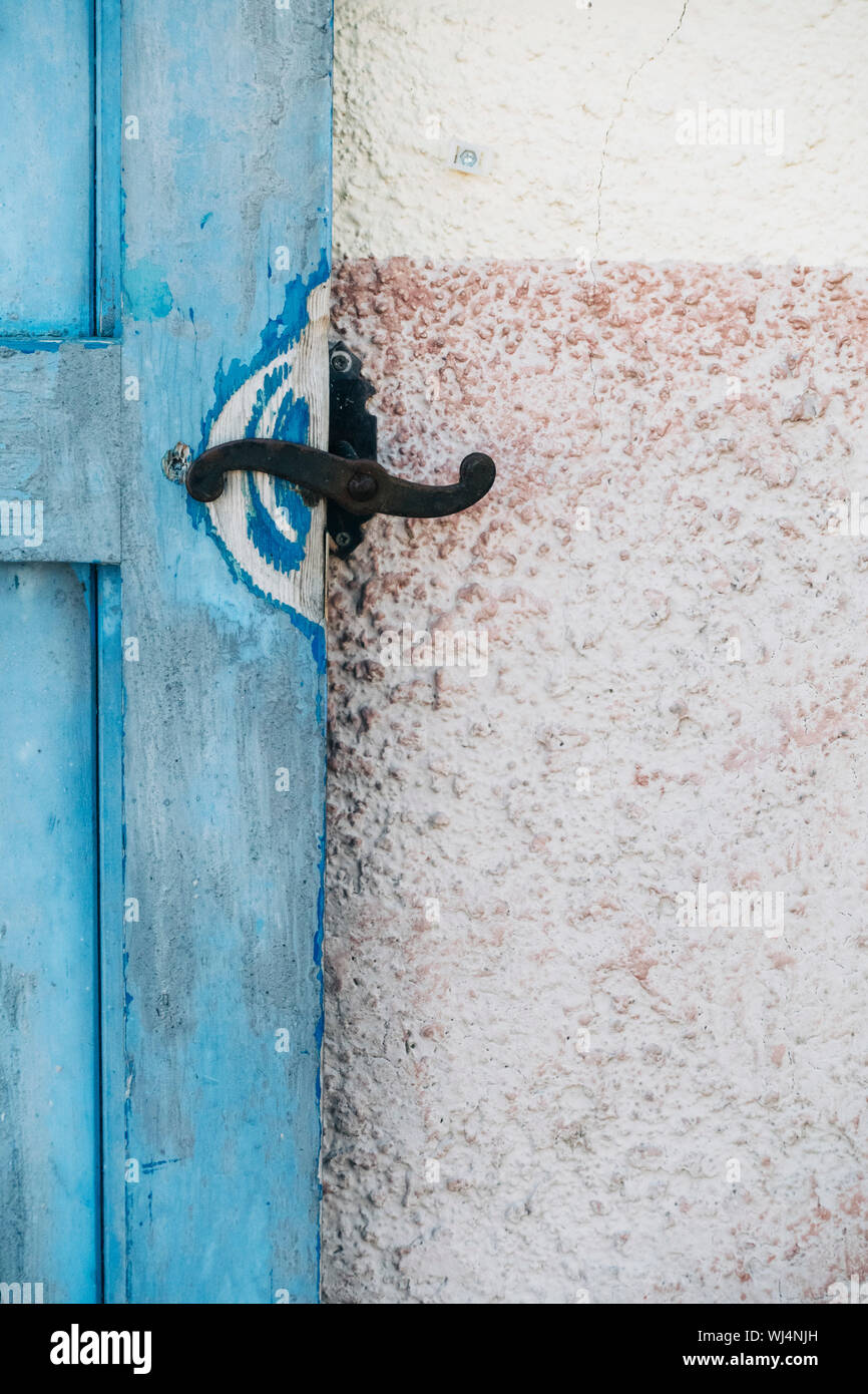Iron latch on blue wooden door Stock Photo - Alamy