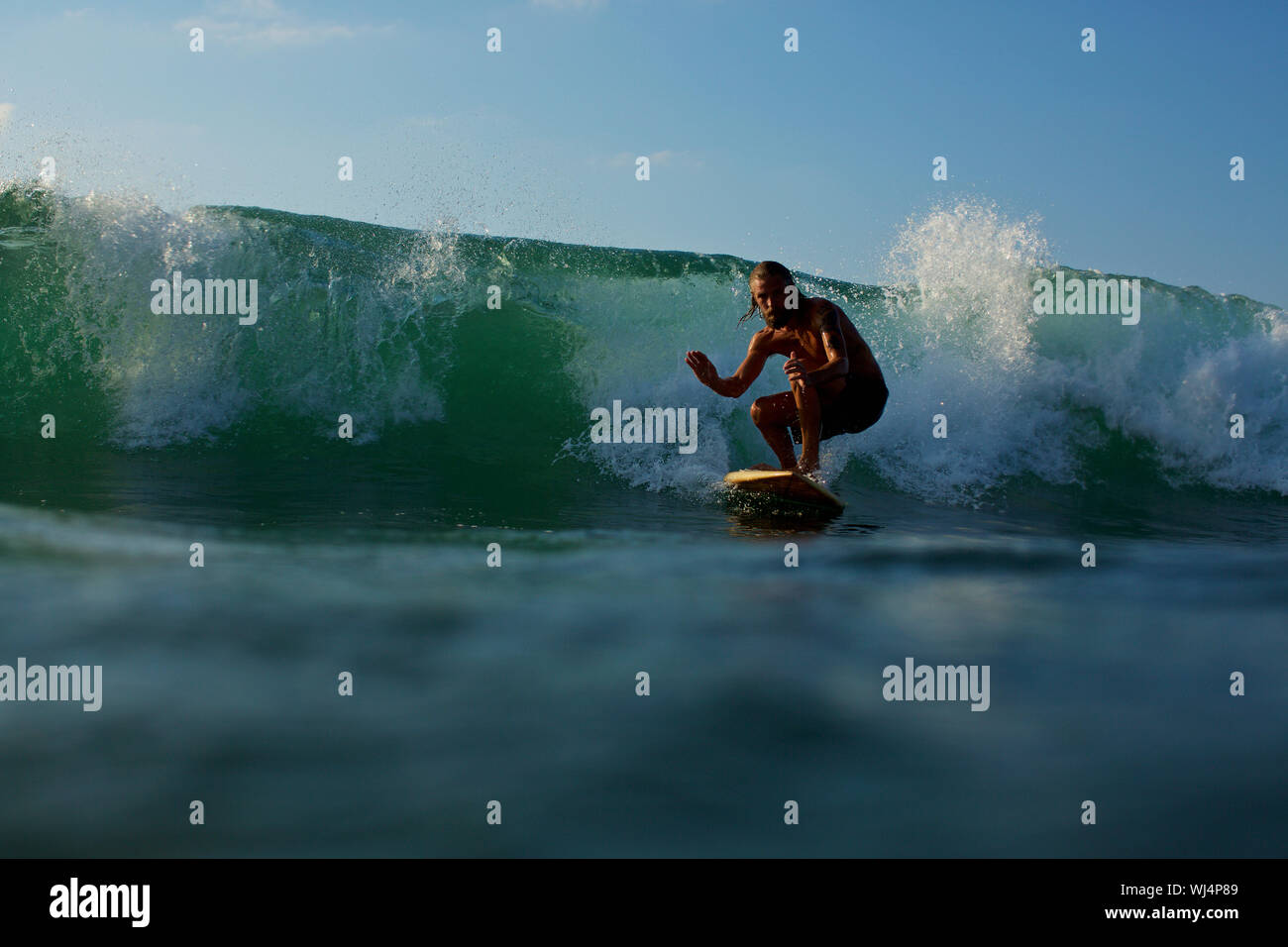 Male surfer riding ocean wave Stock Photo - Alamy