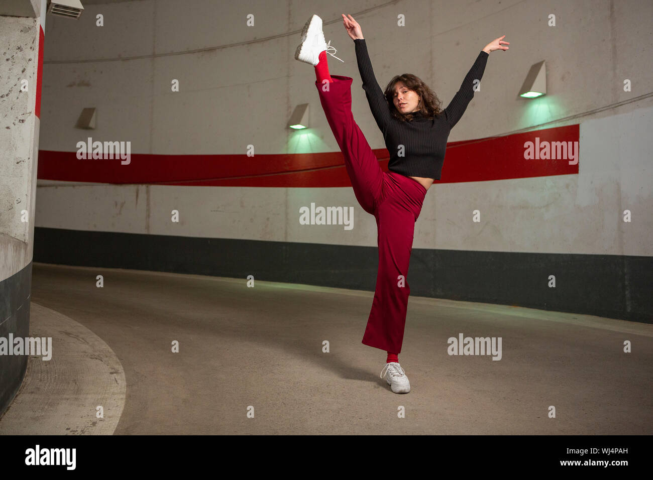 Portrait confident young woman dancing in tunnel Stock Photo - Alamy