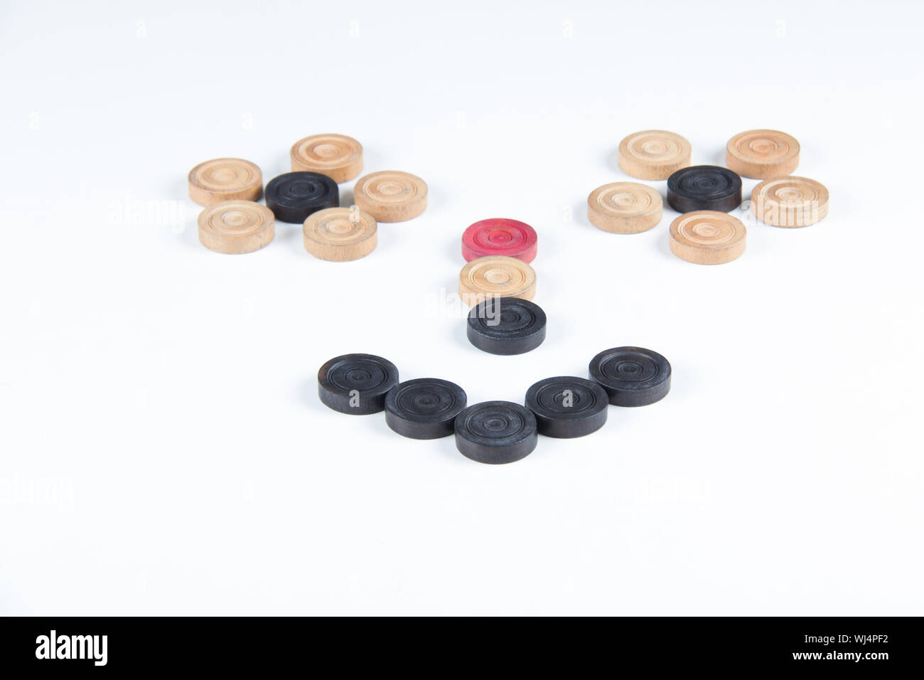 Close up of carrom pieces with representing smiley face Stock Photo - Alamy