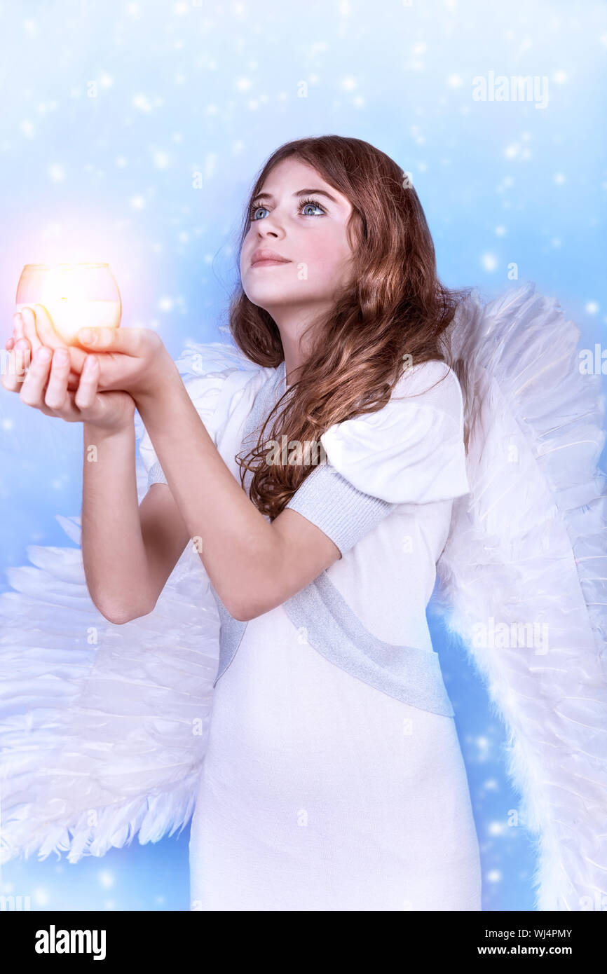 Beautiful angel praying, looking up, holding in hands candle, isolated ...