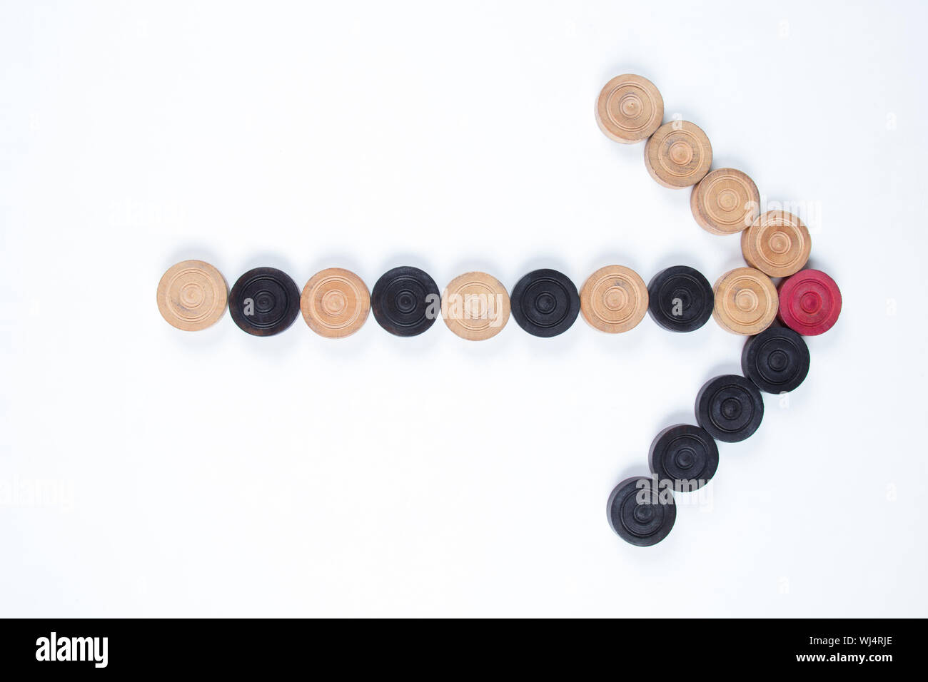 Carrom pieces in shape of arrow sign isolated on white background Stock ...