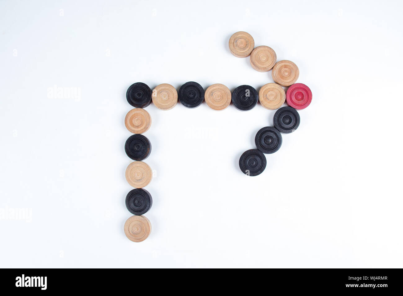 Carrom pieces in shape of arrow sign isolated on white background Stock ...