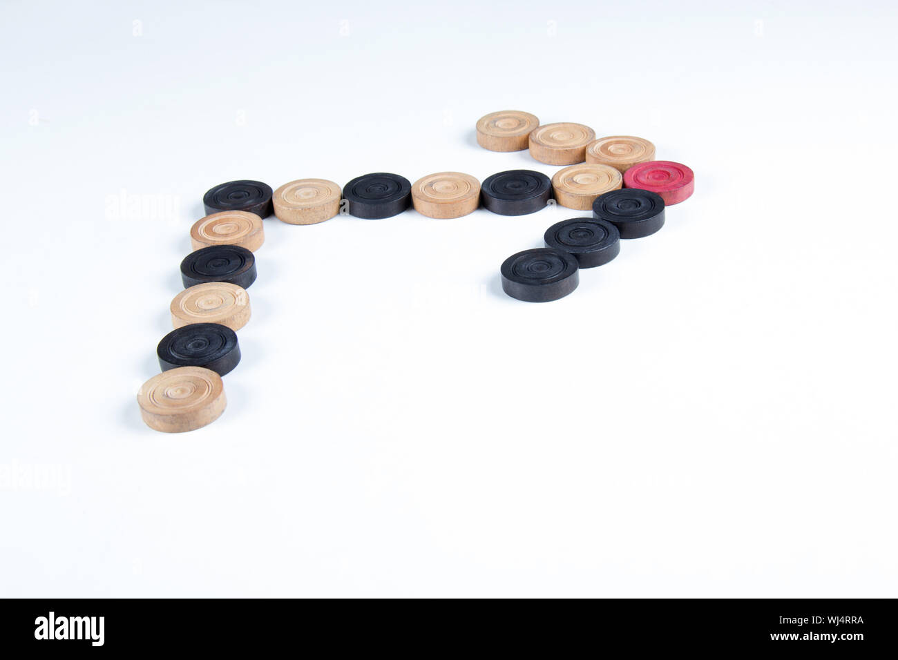 Carrom pieces in shape of arrow sign isolated on white background Stock ...