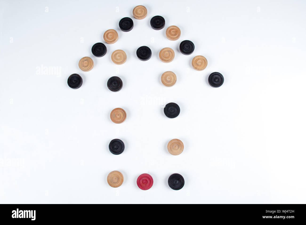 Carrom pieces in shape of arrow sign isolated on white background Stock ...