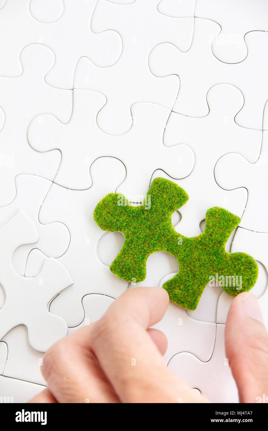 Hand holding a green puzzle piece hi-res stock photography and images ...