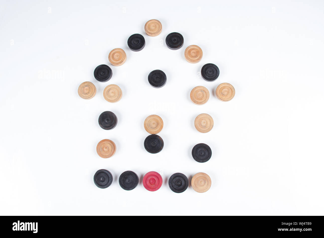 Carrom pieces in shape of arrow sign moving upward Stock Photo - Alamy