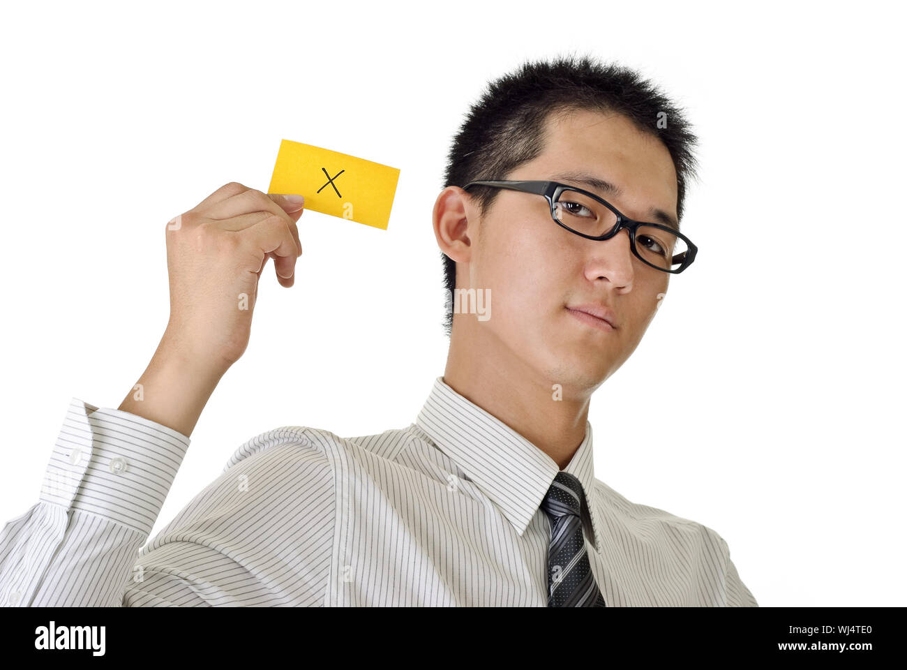 X sign on yellow card holding by business man, closeup portrait of ...