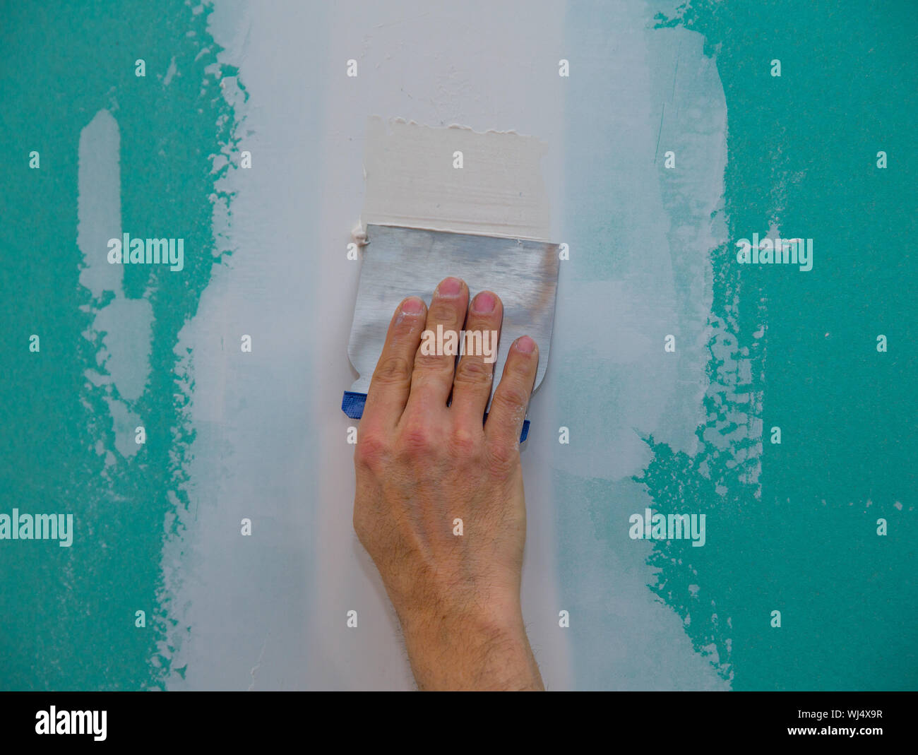 drywall hydrophobic plasterboard in green plastering seam with trowel Stock Photo - Alamy
