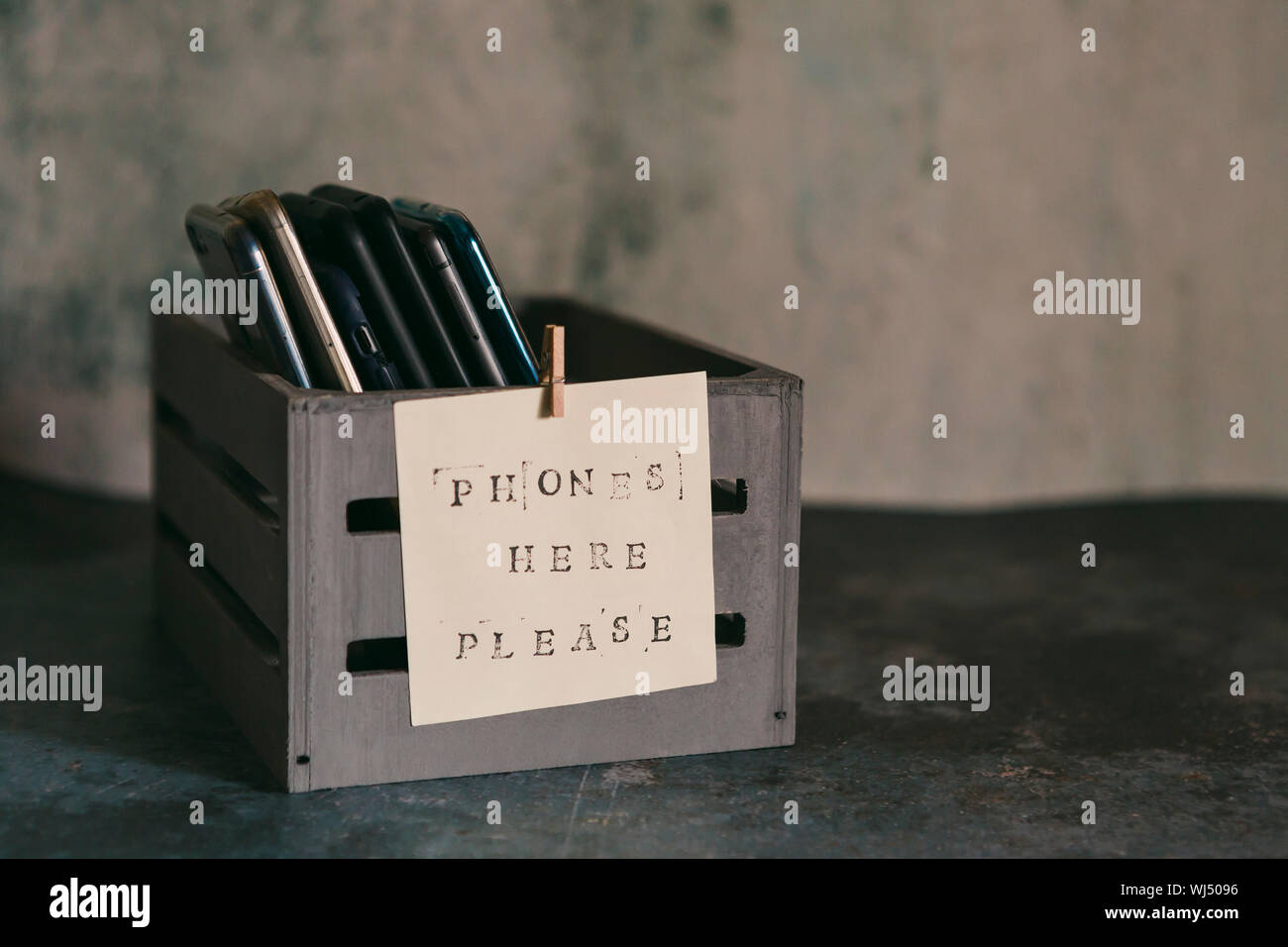 Mobile phone holder with sign Stock Photo - Alamy