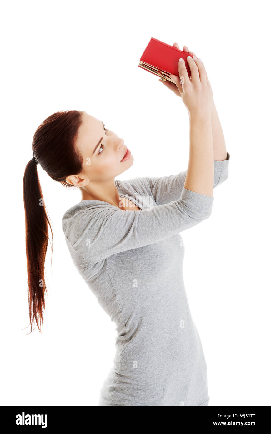 Beautiful young woma checking her empty wallet. Isolated on white Stock ...