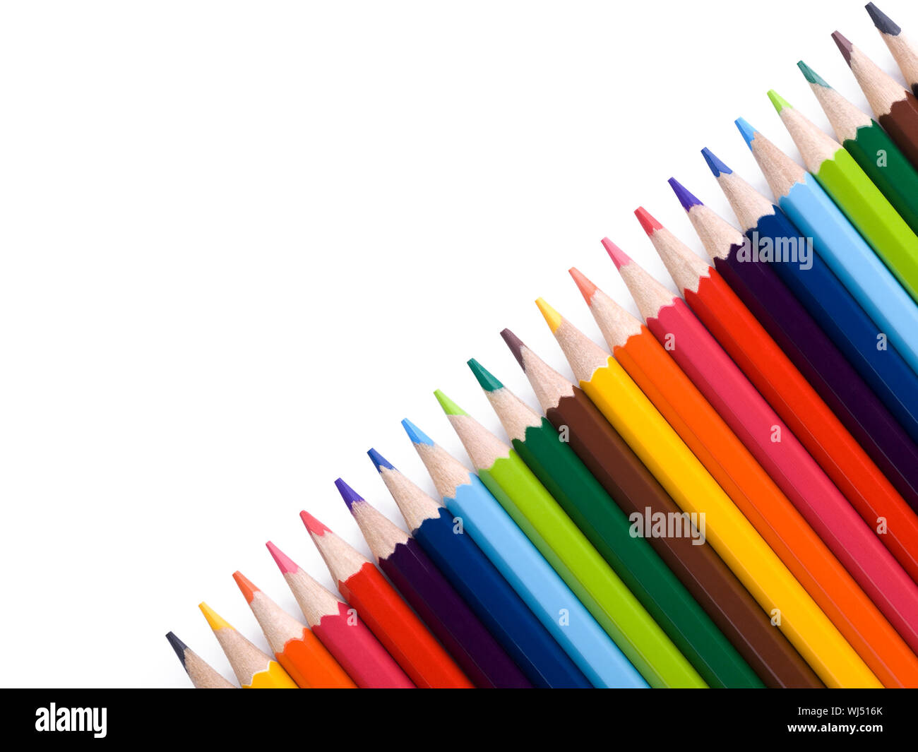 Colored pencils form a diagonal over a white background. Copy space ...