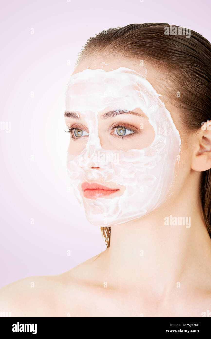 Beautiful woman with clay facial mask Stock Photo - Alamy