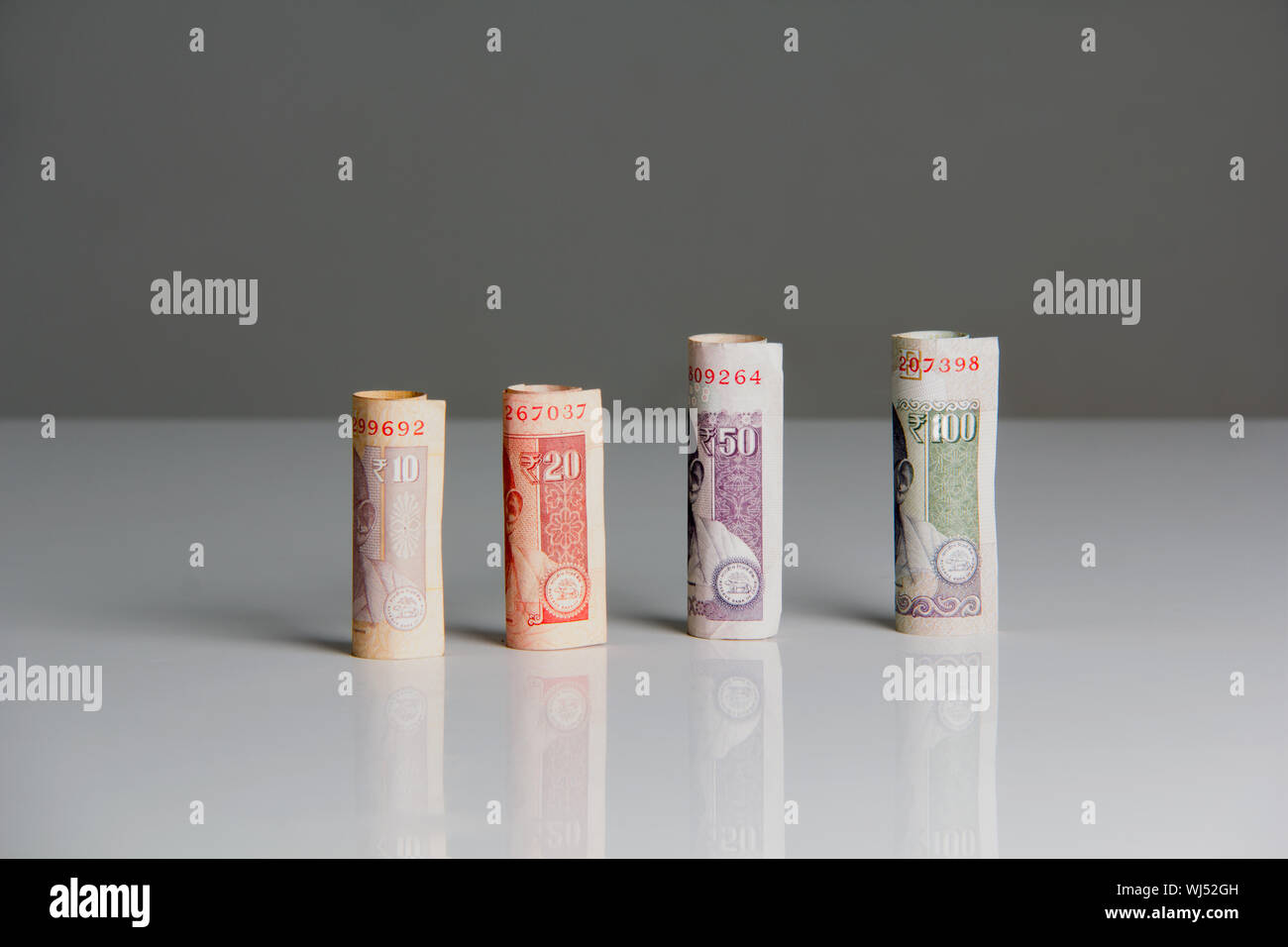 Rolls of banknotes arranged in progressing bar graph shape Stock Photo ...