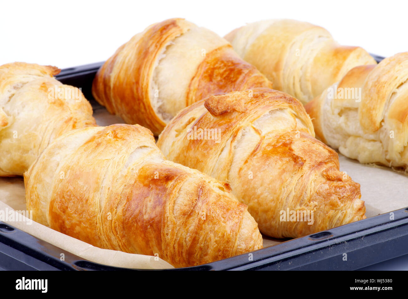 Fresh Baked Croissants on Parchment Paper closeup Stock Photo - Alamy