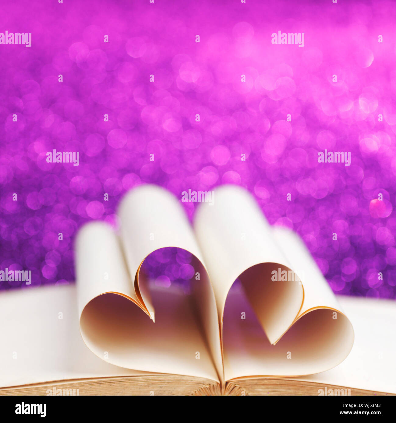 Heart made of blank pages inside a book on glitter background Stock ...