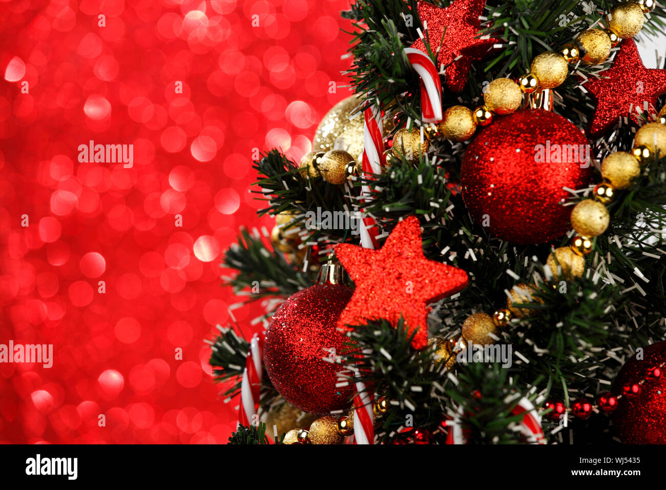 Beautiful decorated Christmas tree on glitter background Stock Photo ...