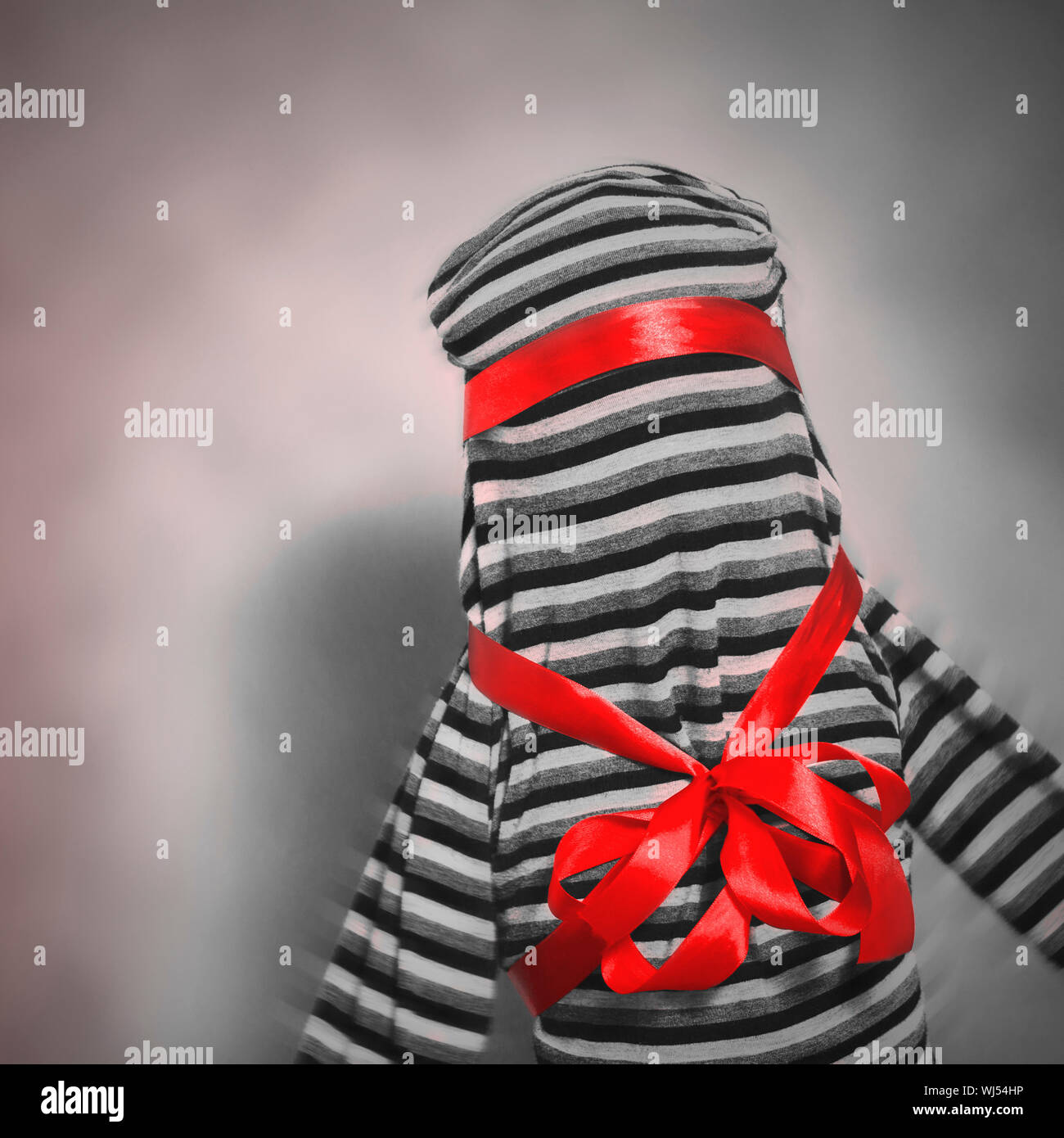 man in a striped dress with a bow on her head Stock Photo - Alamy